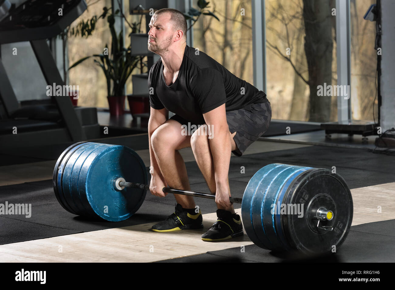 Deadlift attempt. Young man trying to lift heavy barbell Stock Photo ...
