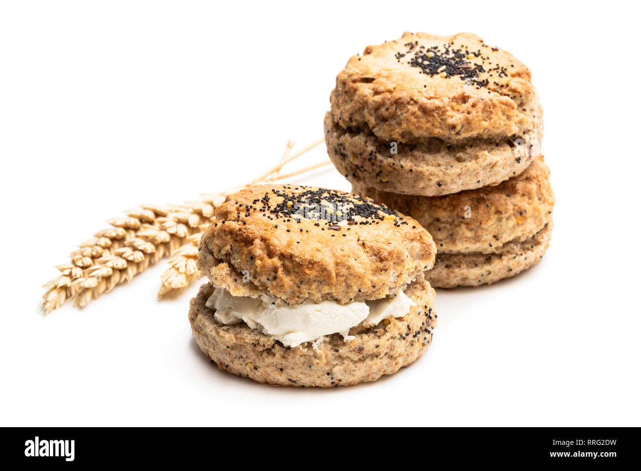 Wholemeal seeded scones stuffed with cream isolated on white Stock ...