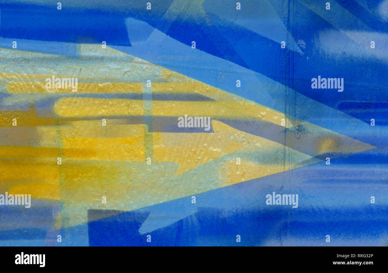Yellow arrow, direction sign, blue background, painted on wall ...