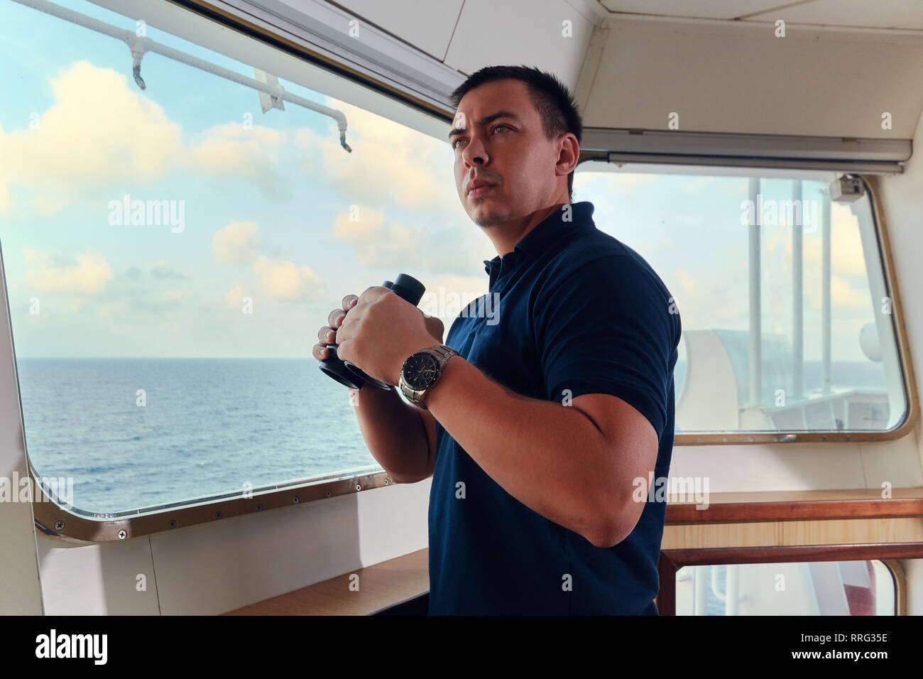 Navigation offcier Pilot on the bridge of a ship underway with ...
