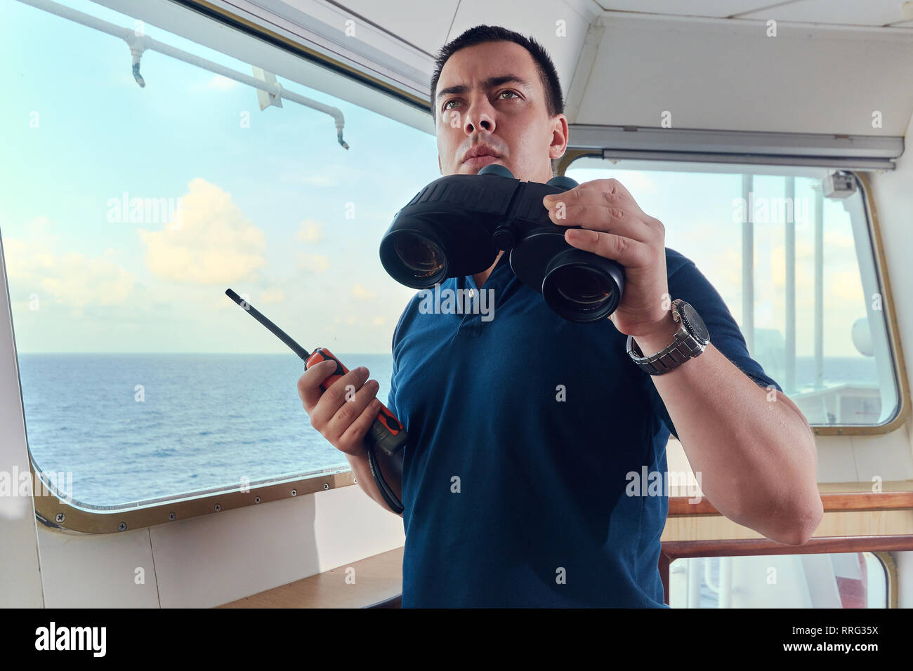 Navigation offcier Pilot on the bridge of a ship underway with ...