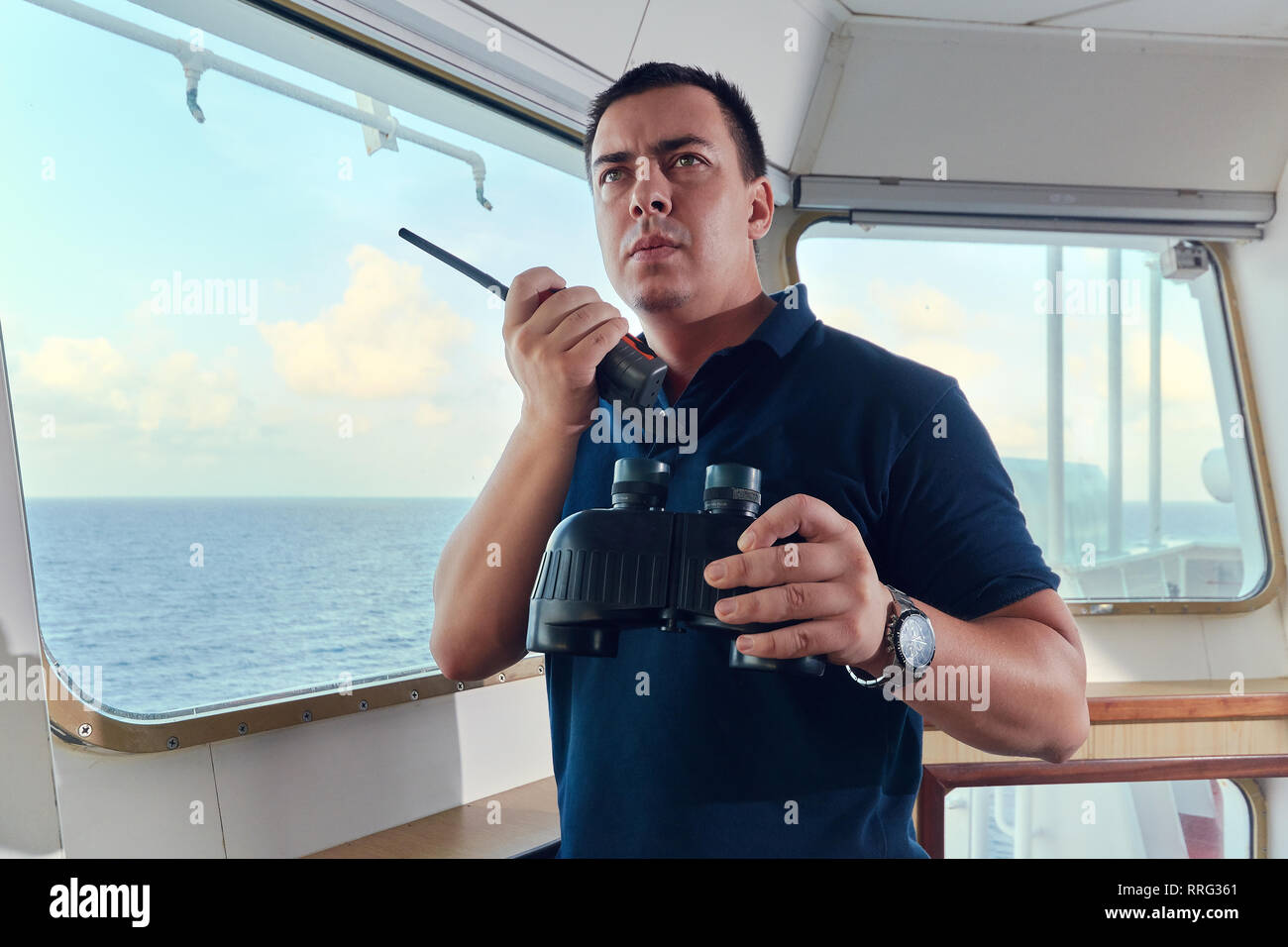 Navigation offcier Pilot on the bridge of a ship underway with ...
