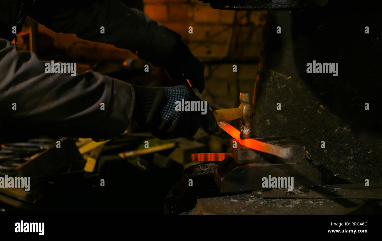 Blacksmith forging molten metal Stock Photo - Alamy