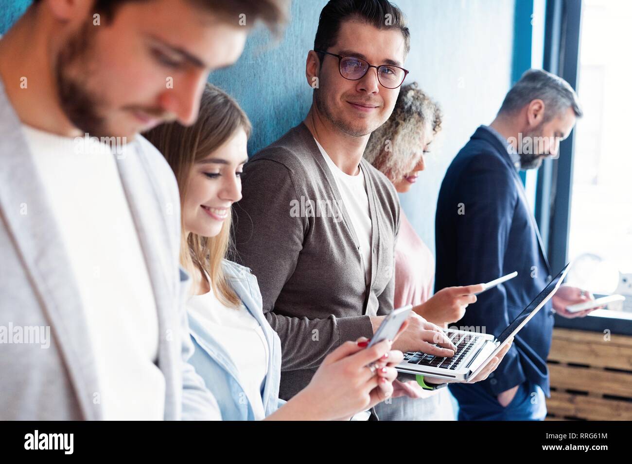 The connected team is an efficient team. Group of businesspeople using ...