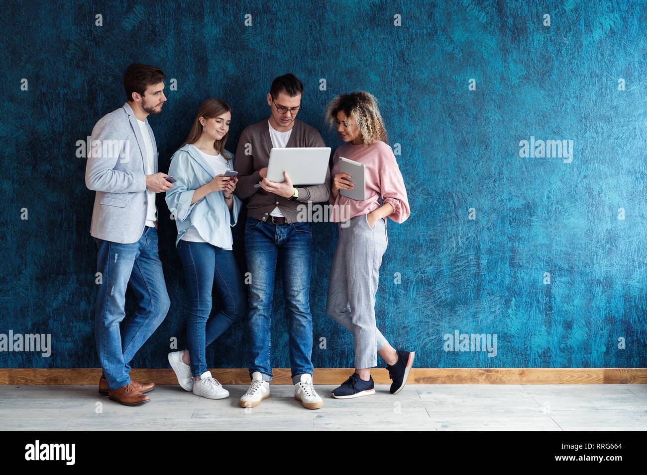 The connected team is an efficient team. Group of businesspeople using ...