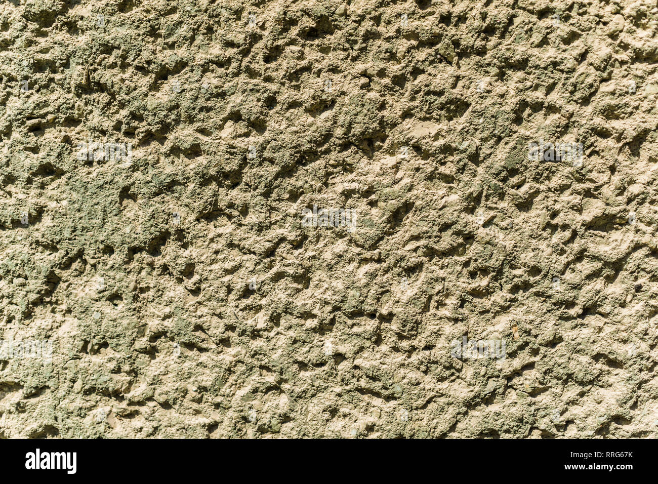 Close-up of an old plaster on a wall of a brick house for texture or ...