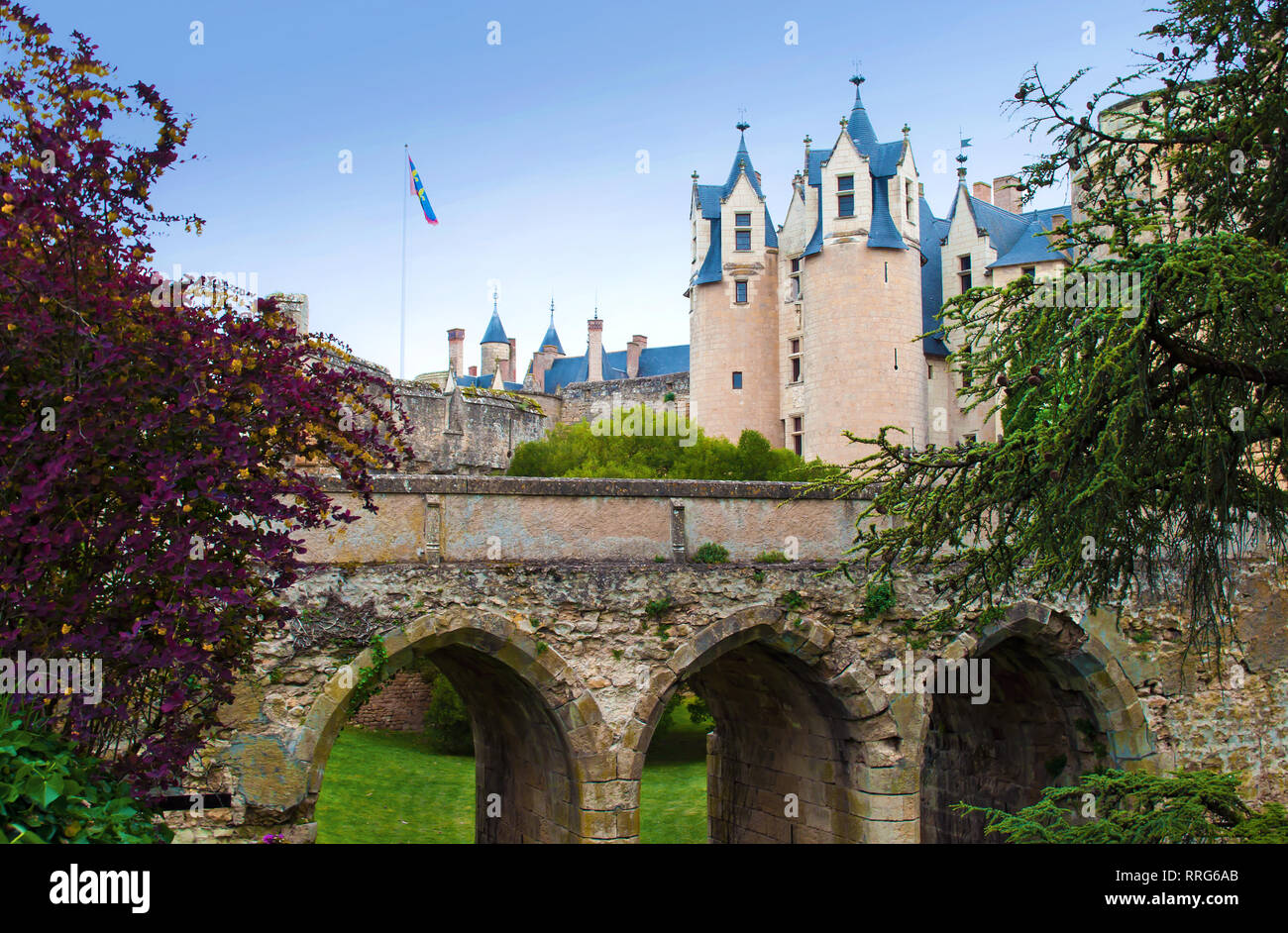 Arched stone bridge near majestic Château de Montreuil-Bellay castle ...