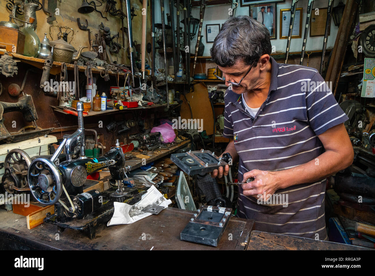 Man in his mechanical repair shop in an alleyway in the Old City ...