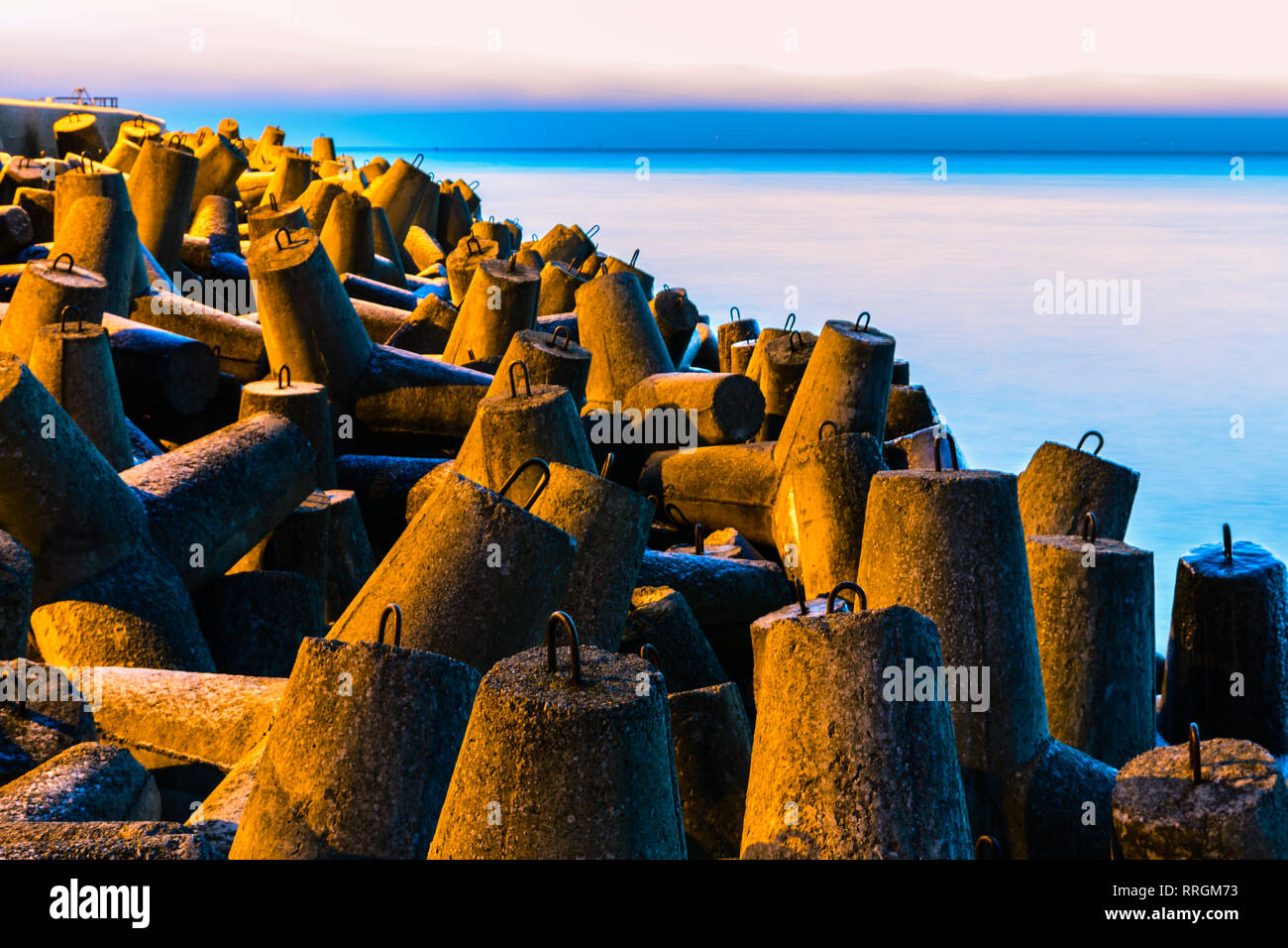 Winter at the beach in the evening. Obstacles against the waves Stock ...