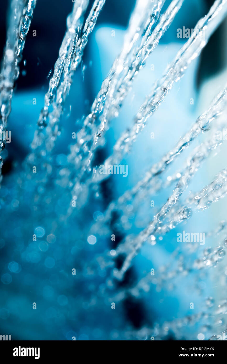 Abstract background of water pouring from above with sun highlights on ...