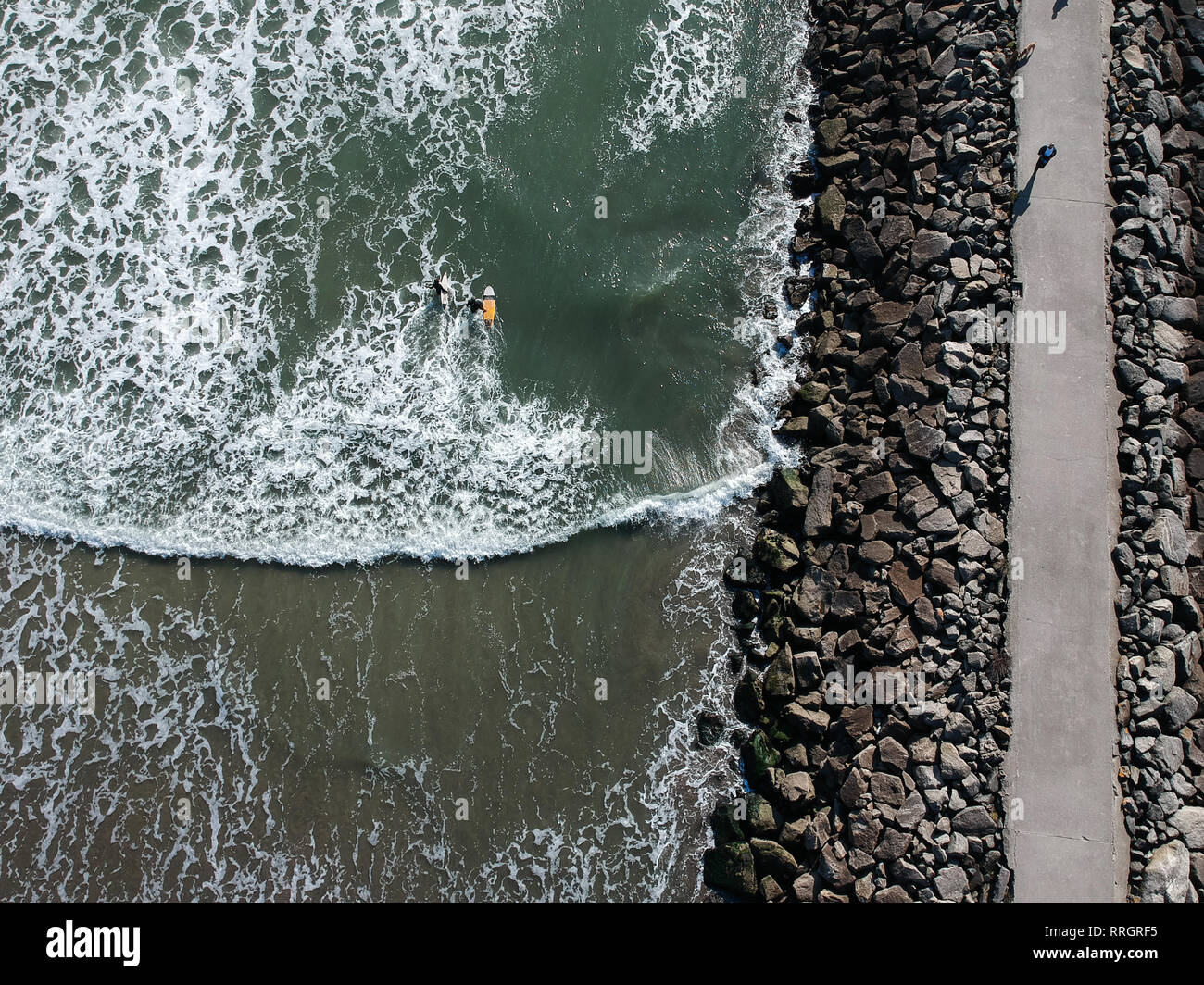 (EDITORS NOTE: Images taken by a drone) Surfers are seen entering the ...