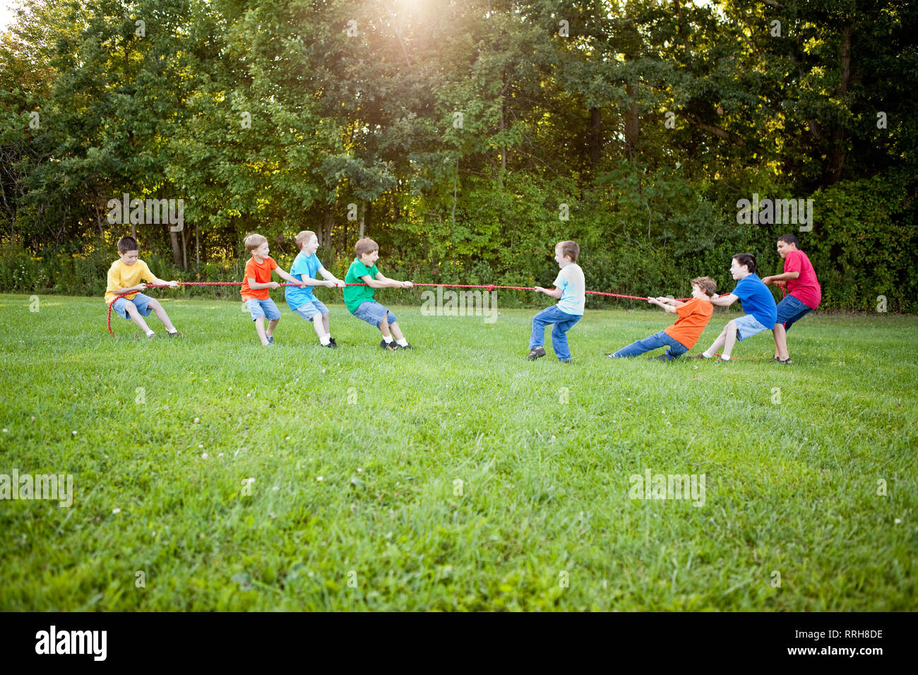 Boys Playing Tug-of-War Game Outside Stock Photo - Alamy
