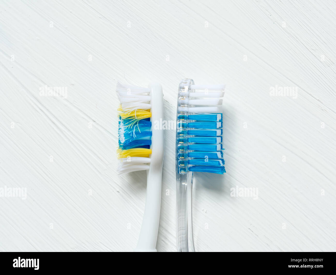 New and heavily used toothbrushes close-up on a white vintage ...
