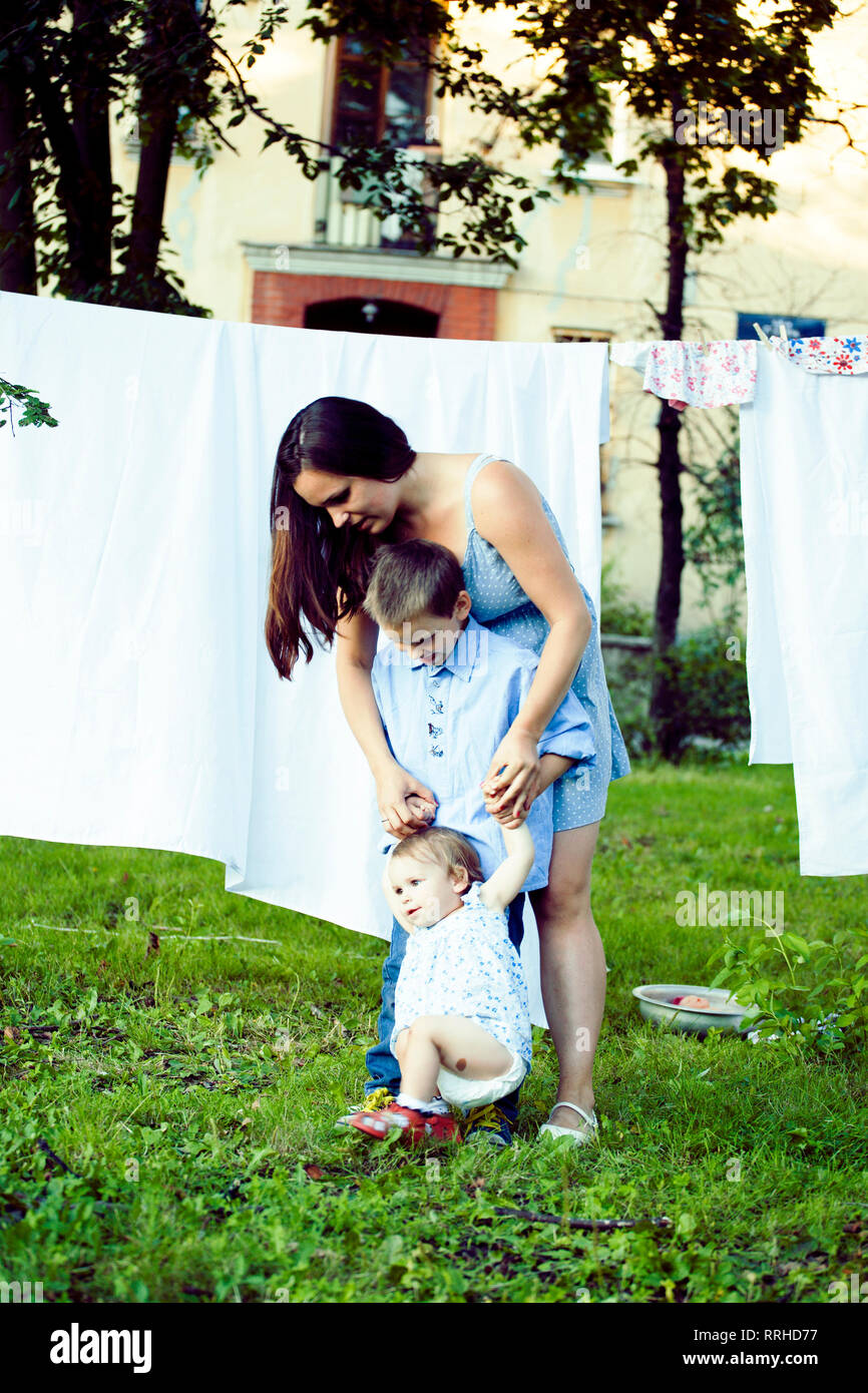 happy family making laundry outside, children helping Stock Photo - Alamy