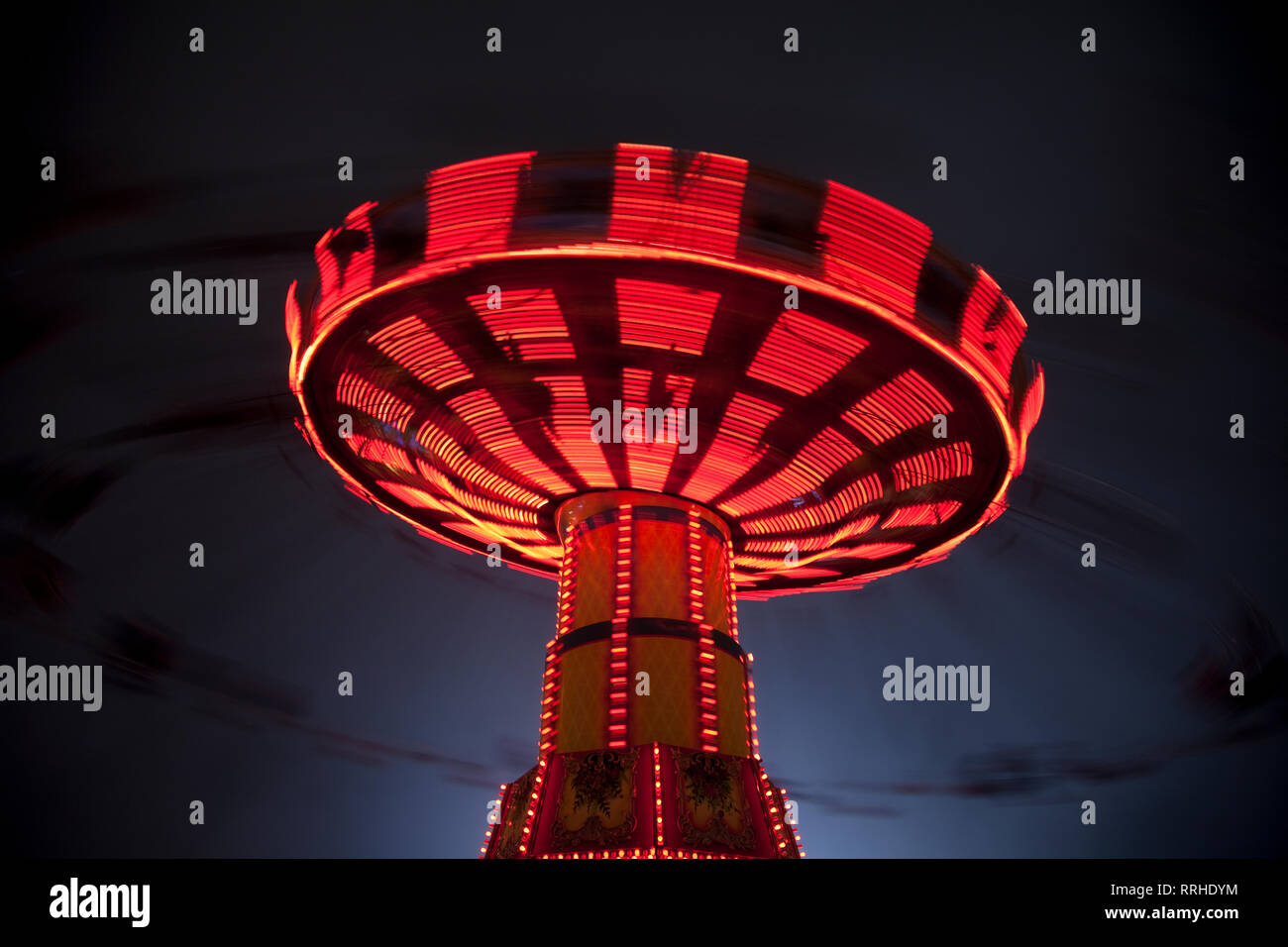 View looking up at the carousel swing ride. Carnival Midway at night ...