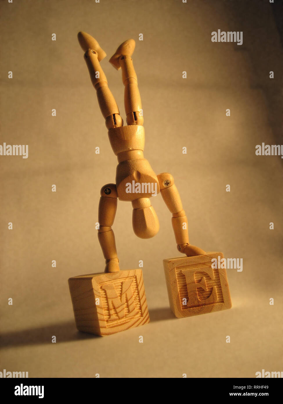 Wooden mannequin Standing on wooden M and E blocks Stock Photo - Alamy