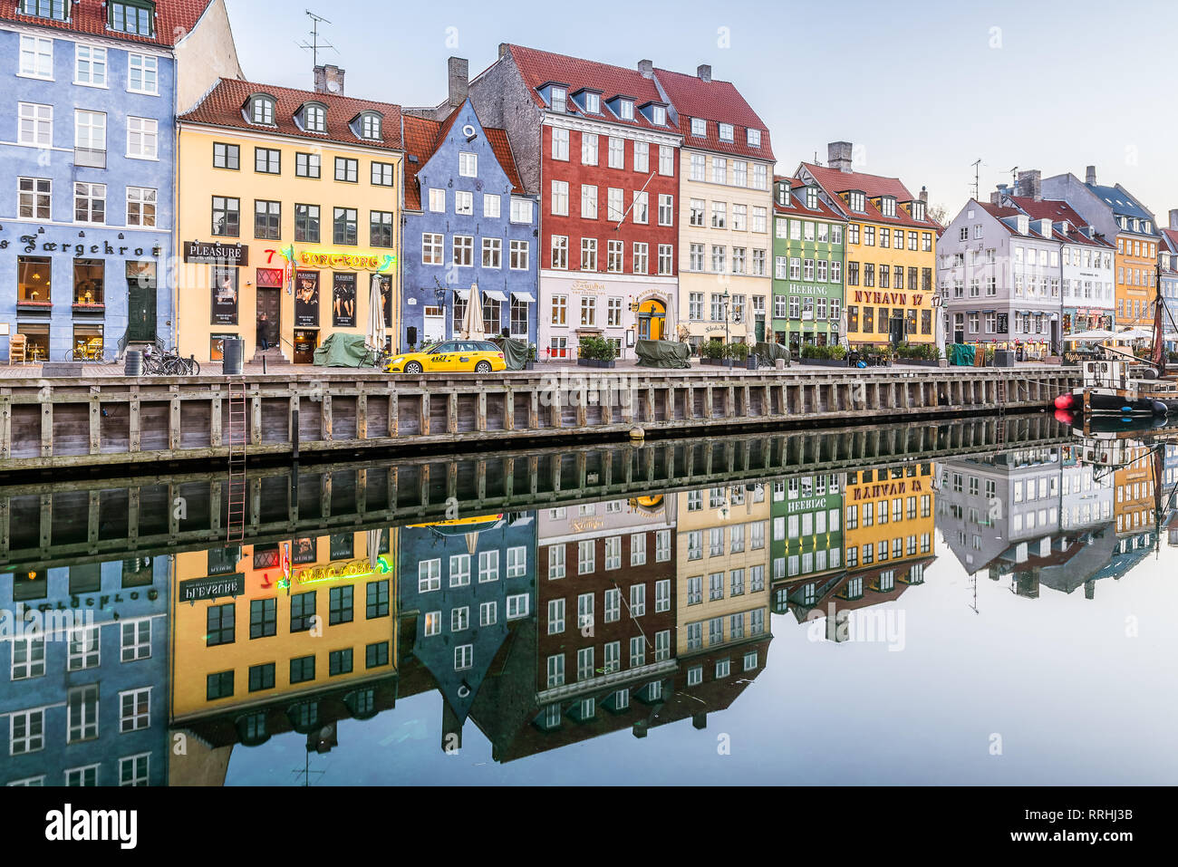 Reflections of colourful houses in the calm water of Nyhavn Canal in ...