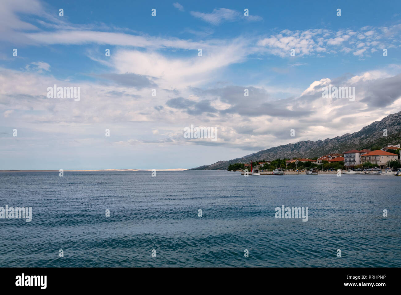 Sea landscape, land view from the perspective of the sea. Blue sky with ...