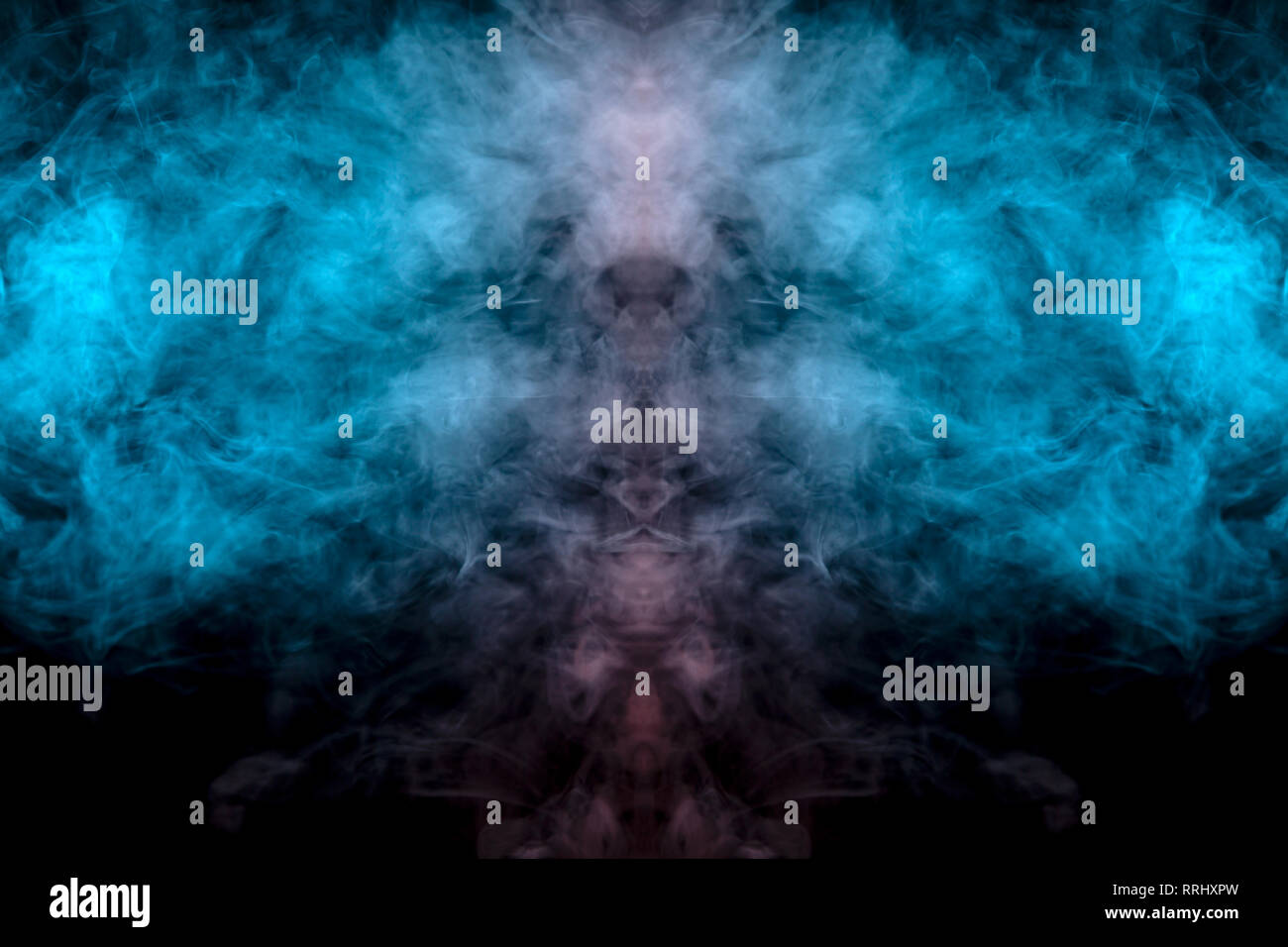 Mystical pattern of green, blue and pink colored smoke in the shape of ...