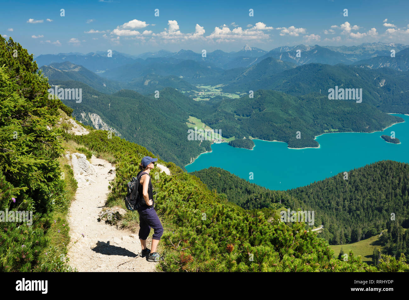 Hiker enjoying the view to Walchensee Lake on trail to Herzogstand ...