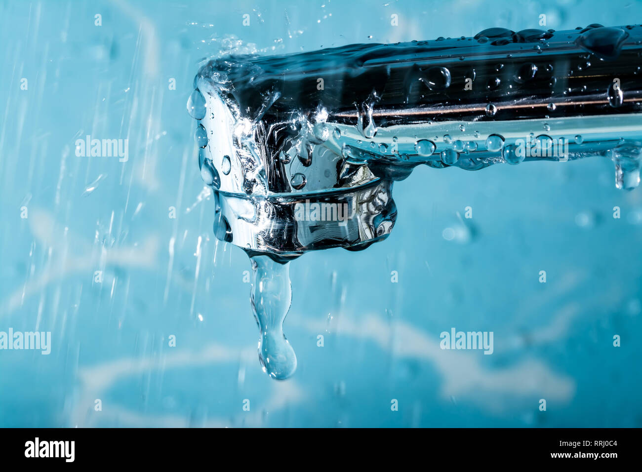 Water flows from a modern chromed water tap faucet macro close-up Stock ...