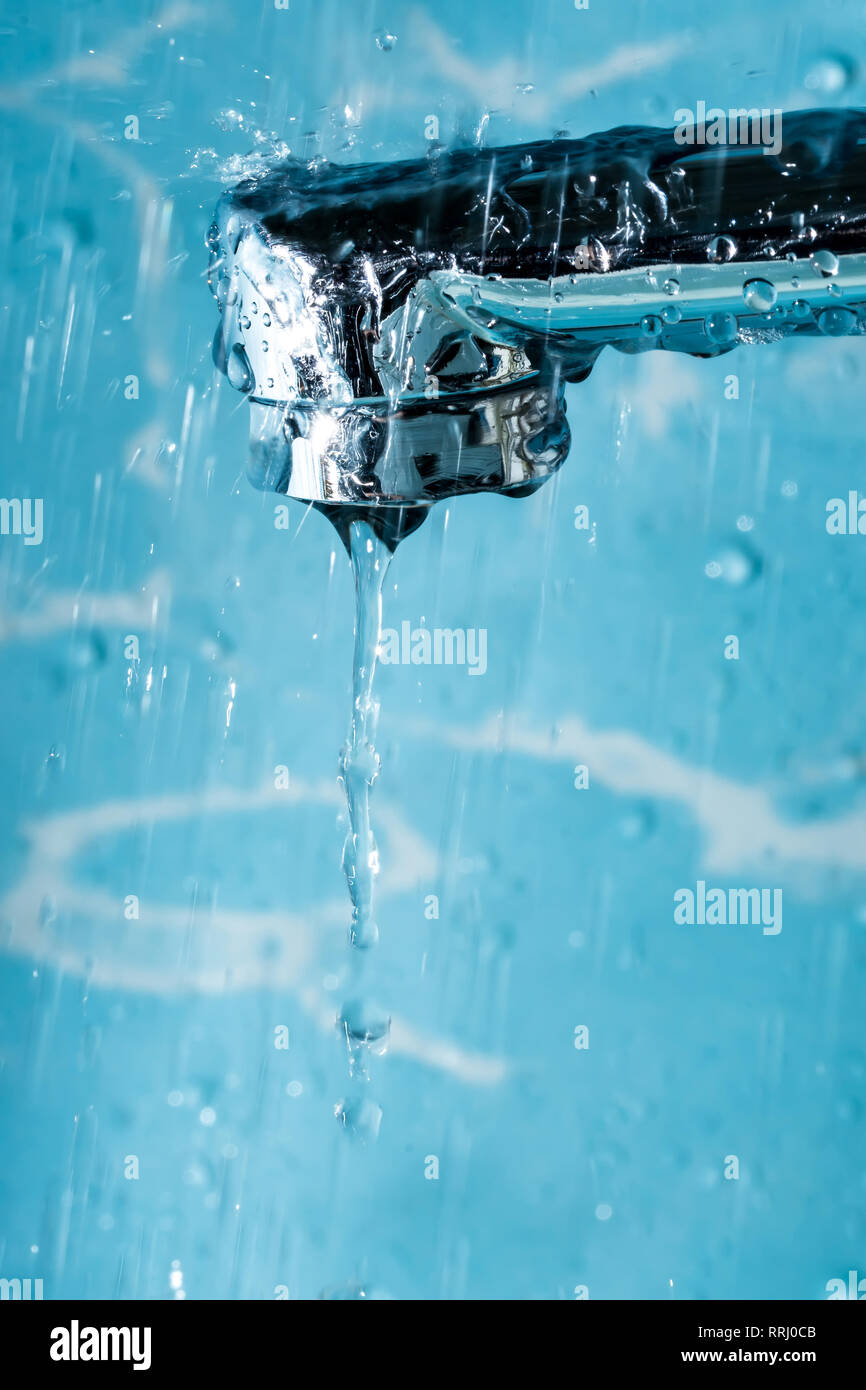 Water flows from a modern chromed water tap faucet macro close-up Stock ...