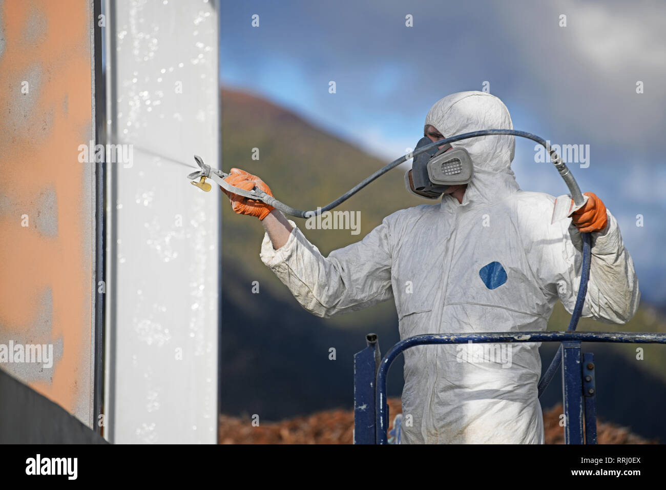 Tradesman spray paints the steel beams on a construction site Stock ...