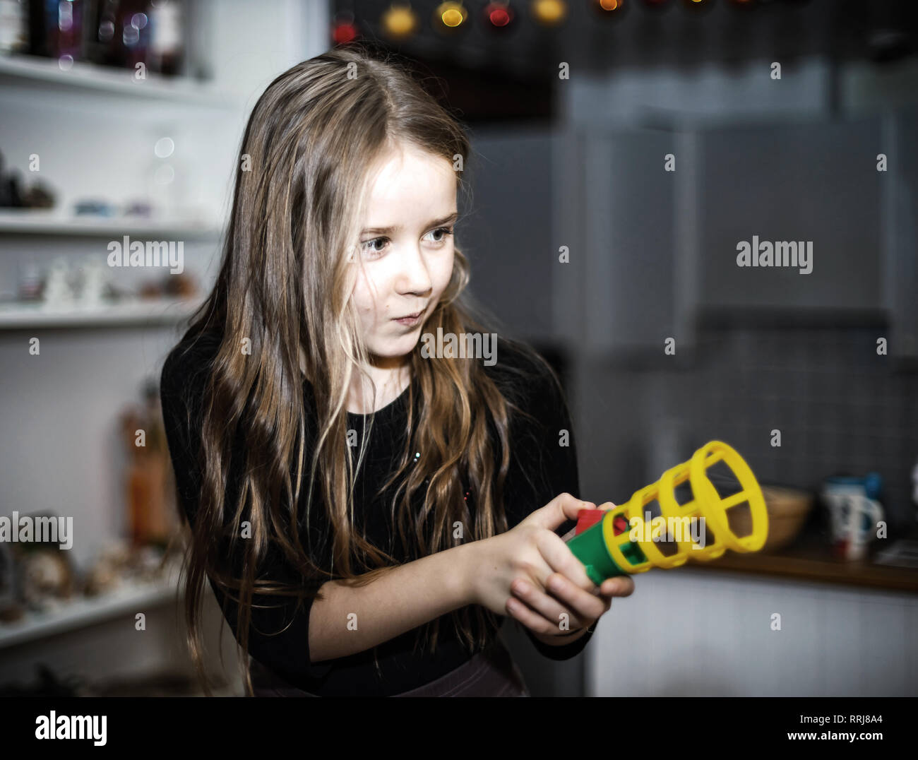 Cute little long haired girl playing games at home, hooligan type of ...