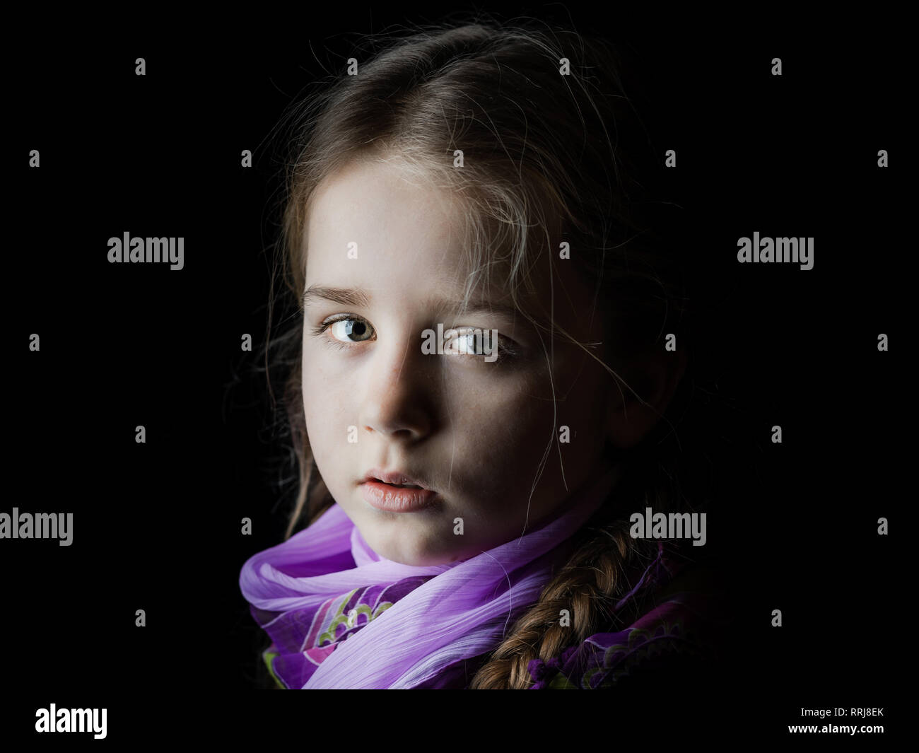 Beautiful little girl portrait on black background, seriously child ...