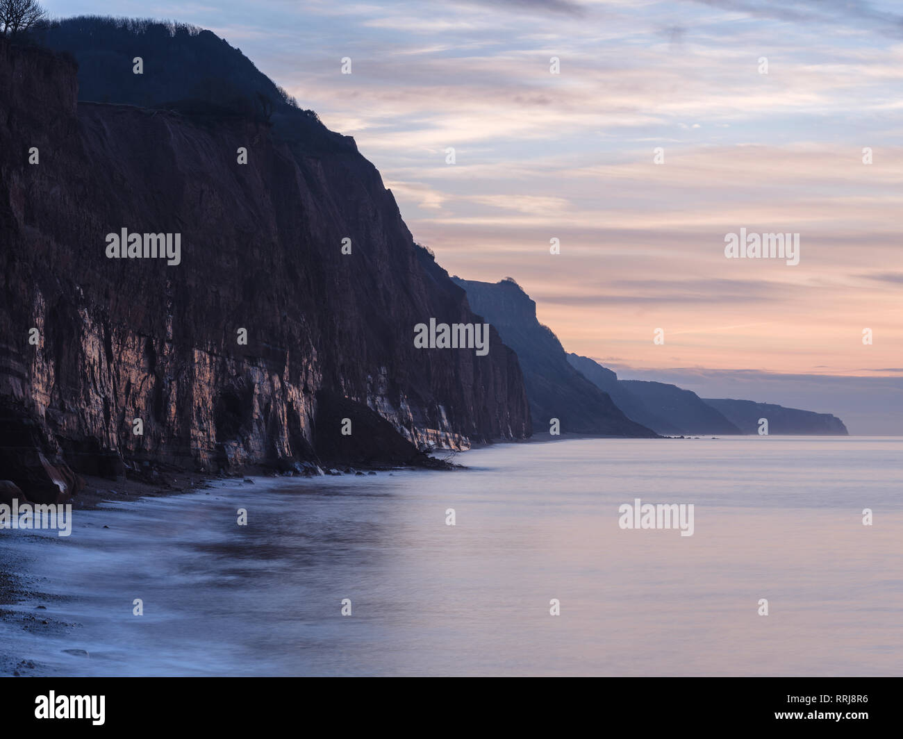 Soft glow of wet rock in pre-dawn twilight on the statuesque Jurassic ...