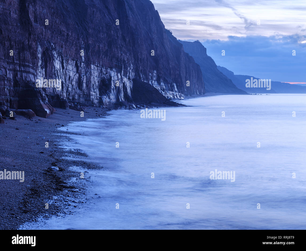 Soft glow of wet rock in pre-dawn twilight on the statuesque Jurassic ...