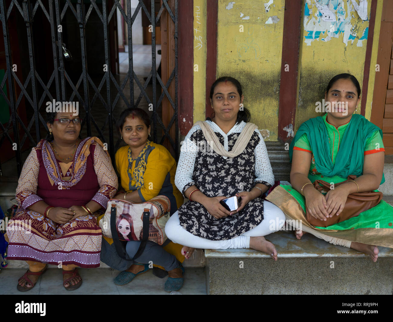 Four women sitting hi-res stock photography and images - Alamy