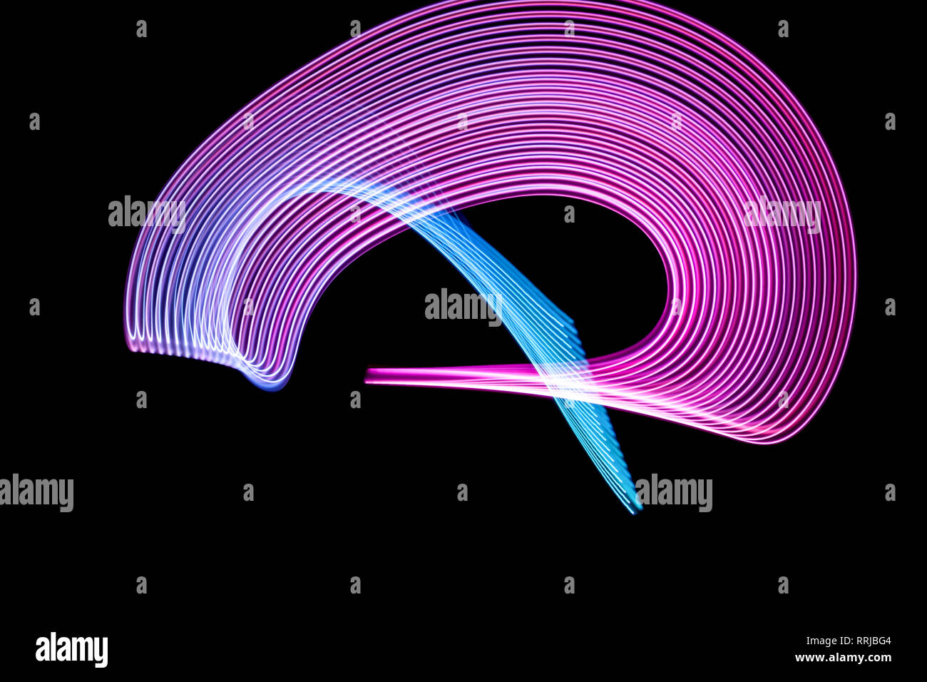 Abstract rainbow neon glowing crossing lines pattern. Dark background of colorful neon glowing ...