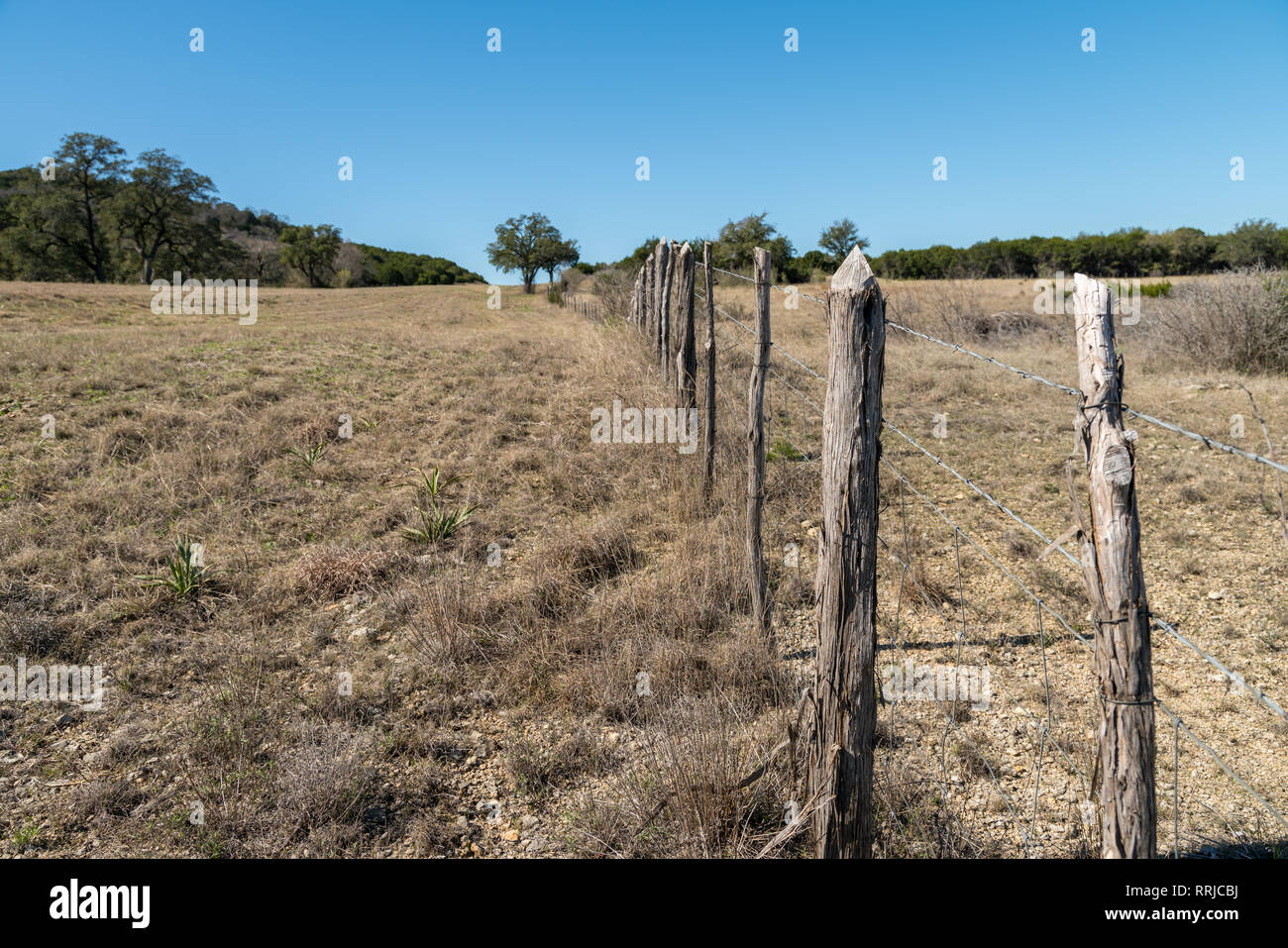 Closed View of Cedar Post Fence With Road in the Background Stock Photo ...