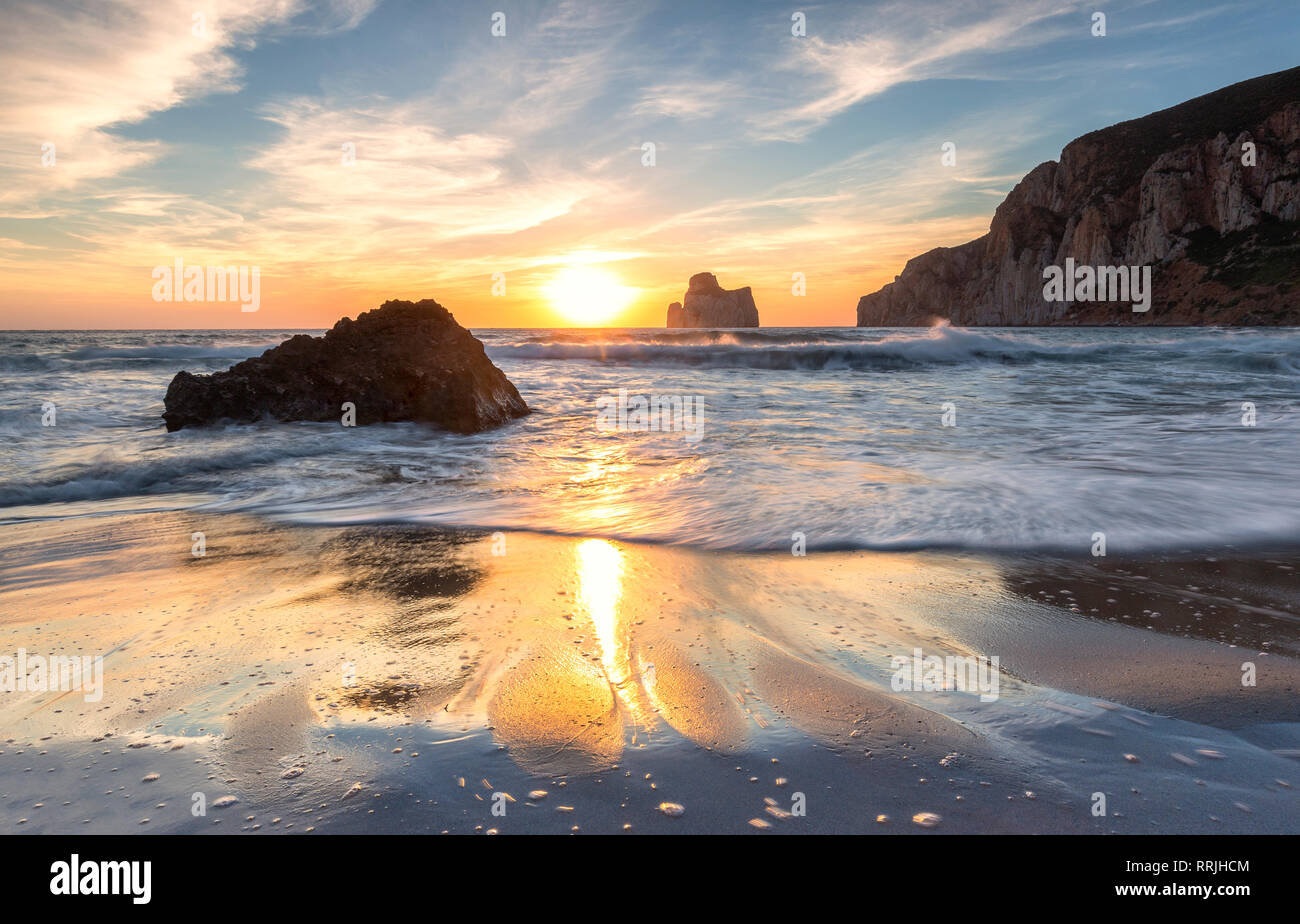 The sunset reflected on the Beach of Masua, Iglesias, Sud Sardegna ...