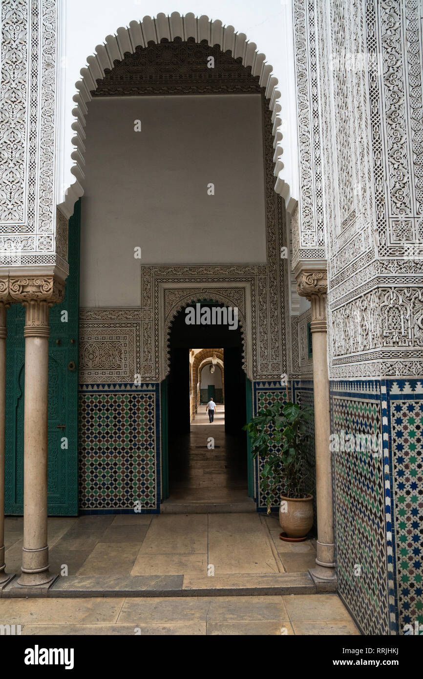 Man wanders down a long corridor decorated in Moorish style, Mahkama du ...