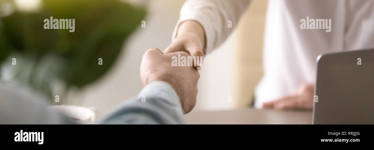 Close up horizontal image male female businesspeople shaking hands ...