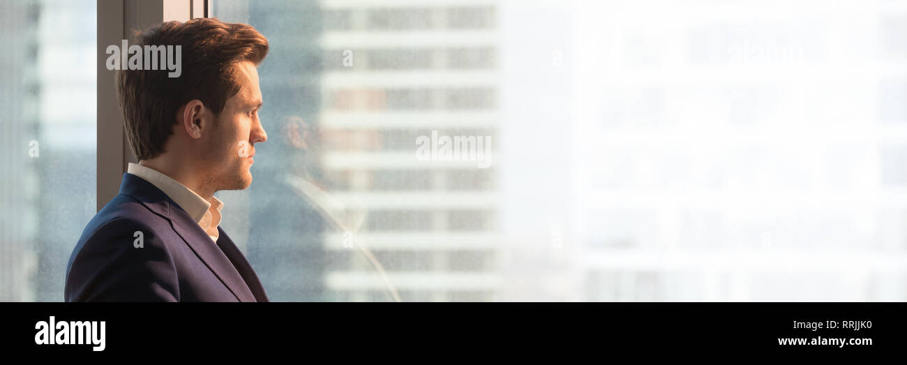 Panoramic image businessman in suit looking through office window Stock ...