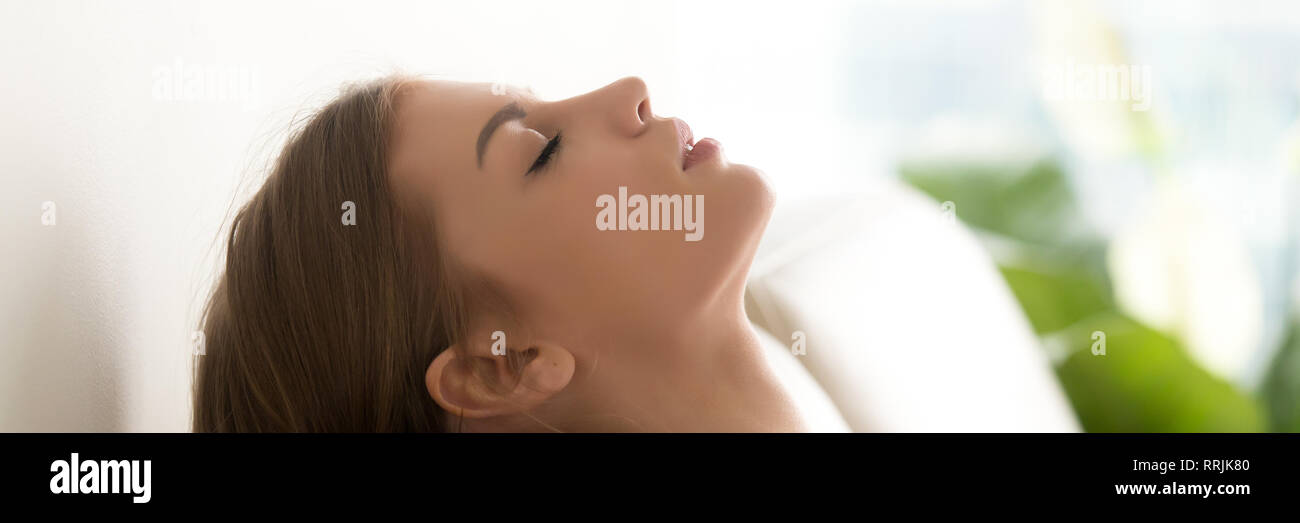 Side view female face with closed eyes resting on couch Stock Photo - Alamy