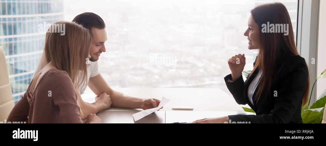 Real estate agent showing to married couple new house plan Stock Photo ...