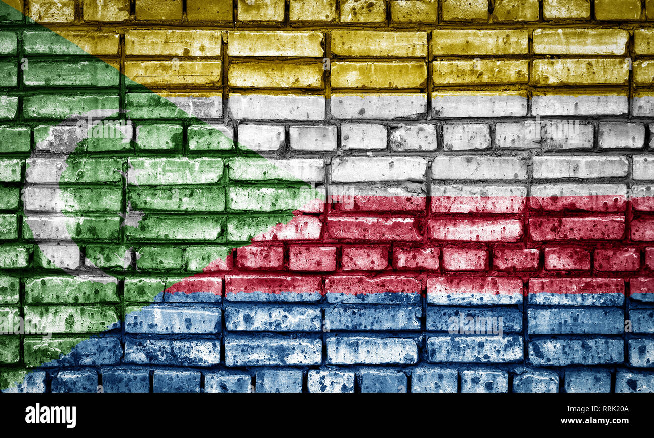 National flag of Comoros on a brick background. Concept image for ...