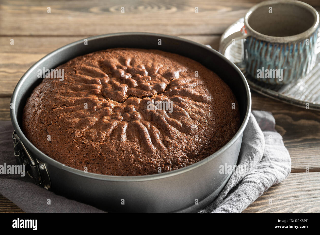 Freshly baked delicious smelling chocolate cake cools down in culinary ...