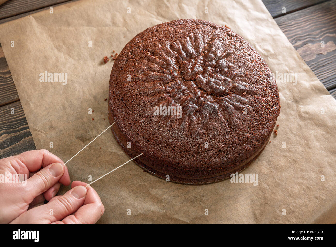 Steps in making chocolate cake.Person slices the cake with culinary ...