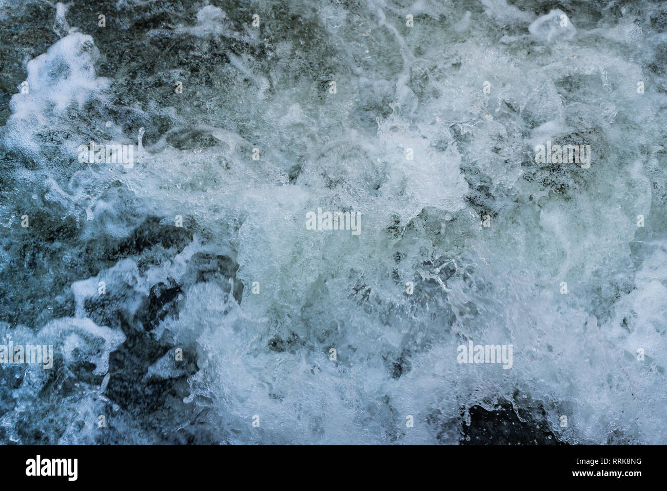 Foaming water in a rushing river Stock Photo - Alamy