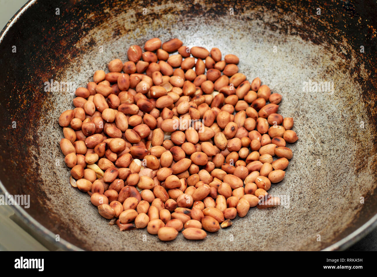 Roasting peanut in a frying pan, Maharashtra, India Stock Photo - Alamy