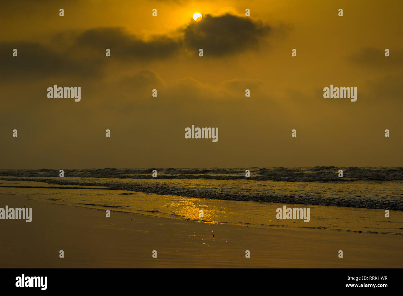 golden sunrise sunset twilight hour. sun rays reflecting on sea water ...