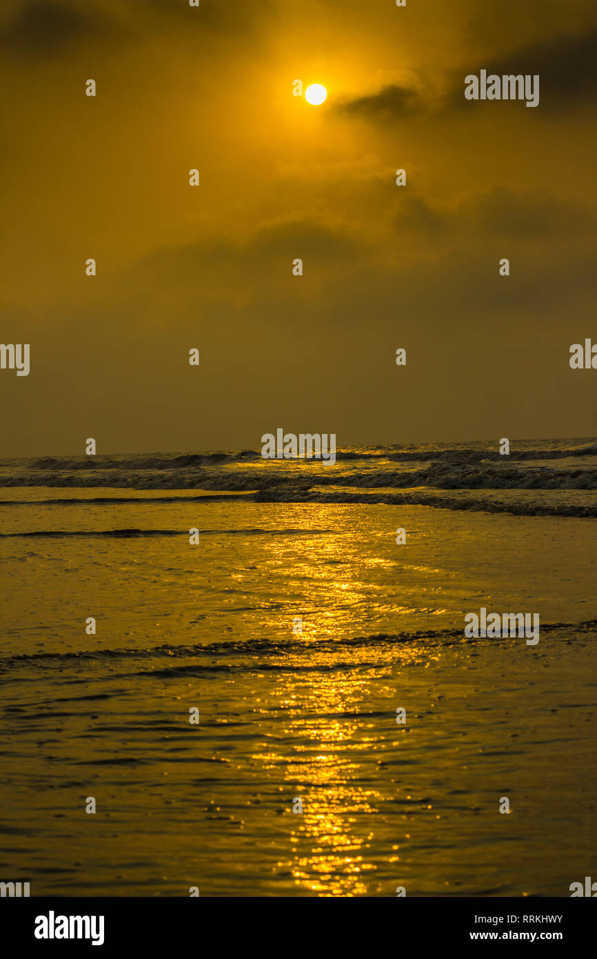 golden sunrise sunset twilight hour. sun rays reflecting on sea water ...