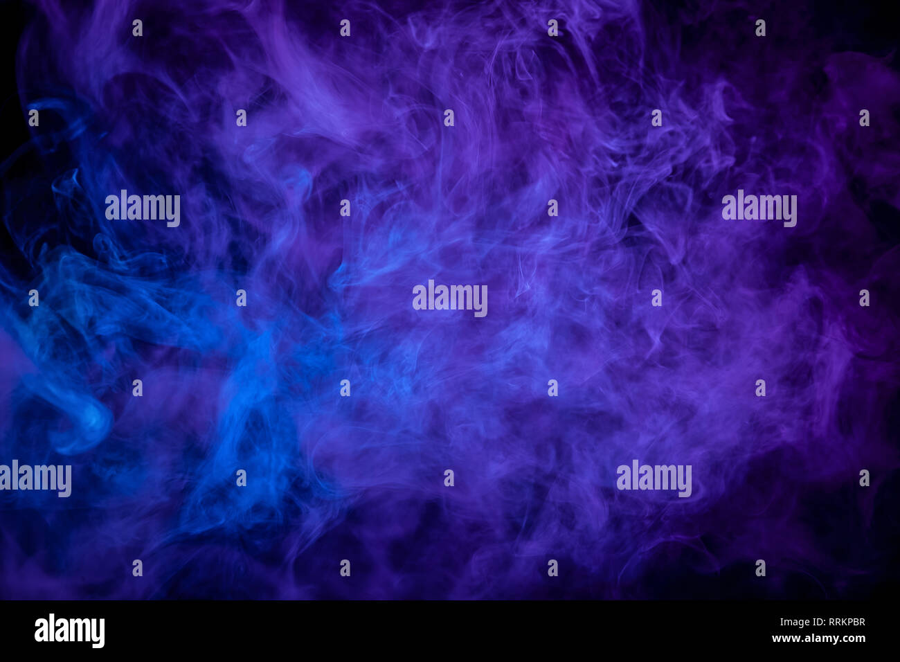 Thick colorful blue smoke on a black isolated background. Background ...