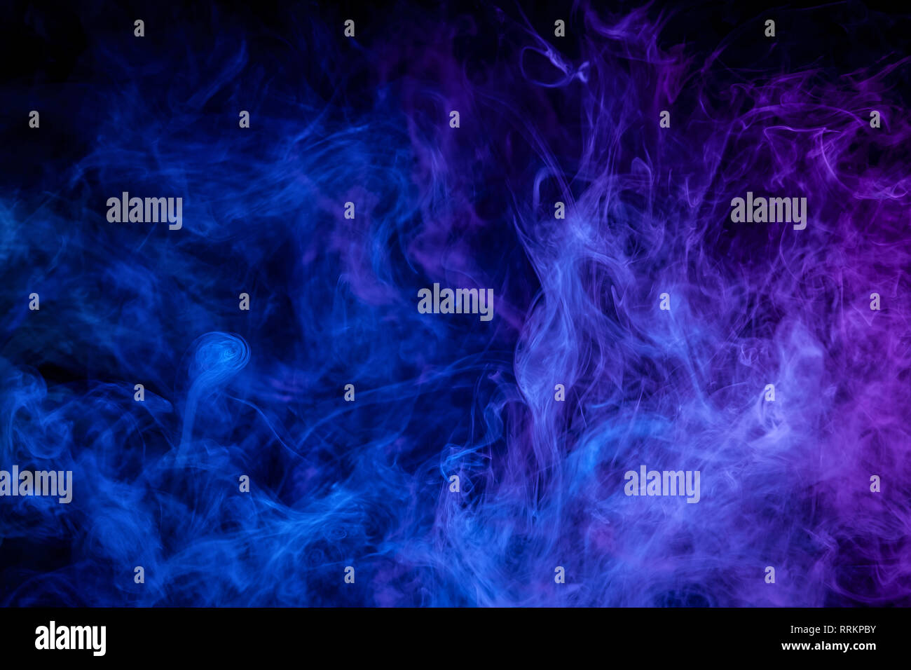 Thick colorful blue smoke on a black isolated background. Background ...