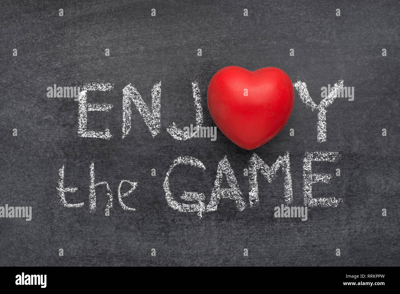 enjoy the game phrase handwritten on blackboard with heart symbol ...